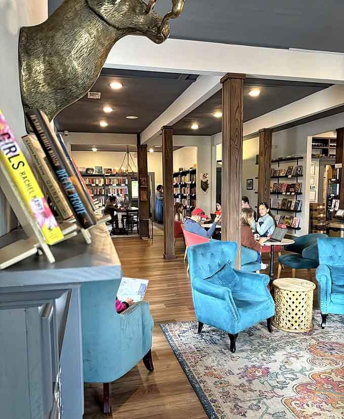 Those turquoise velvet chairs aren't just furniture, they're invitations to spend the entire afternoon reading and sipping.