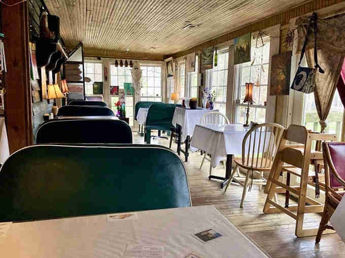 Mismatched chairs, tin ceilings, and art everywhere. This is where bohemian charm meets serious comfort food.