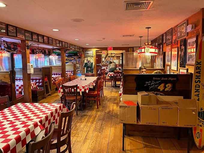 Red checkered tablecloths and warm lighting create the perfect atmosphere for serious pizza appreciation and family gatherings.