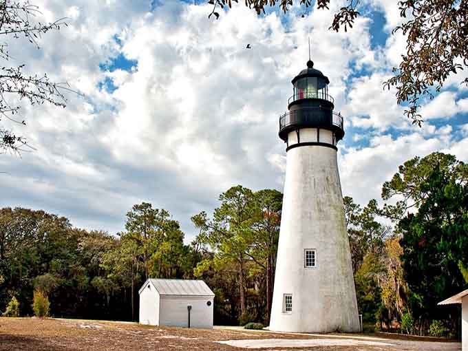 Standing tall and proud in white, this classic lighthouse watches over the landscape with timeless grace and simple beauty.