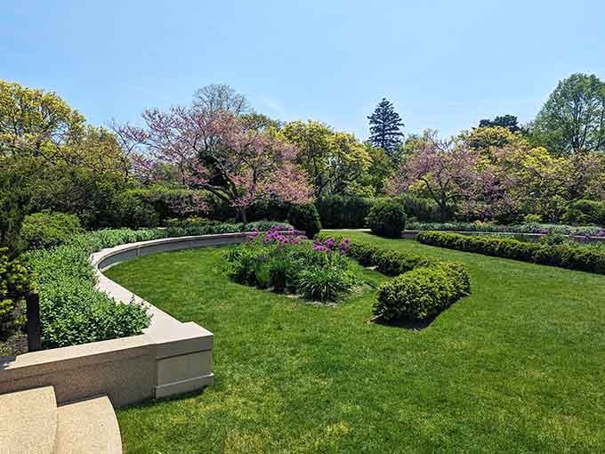 Perfectly manicured lawns frame this formal garden where every hedge knows its place and every bloom stands at attention.