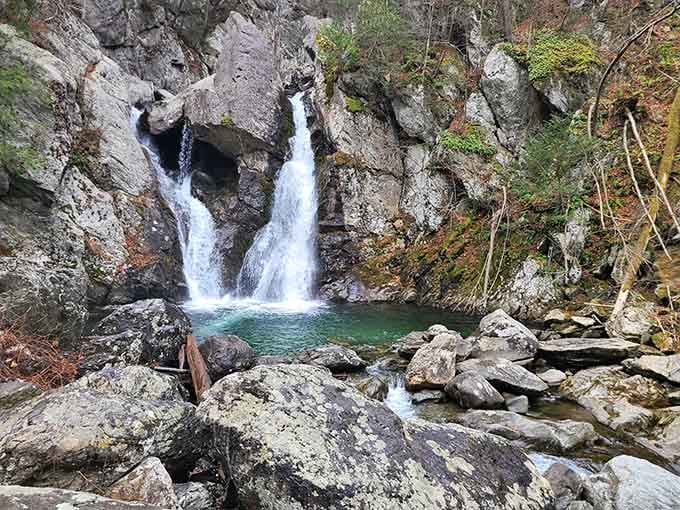 Twin waterfalls plunge into an impossibly turquoise pool, proving Massachusetts has its own slice of paradise hidden away.