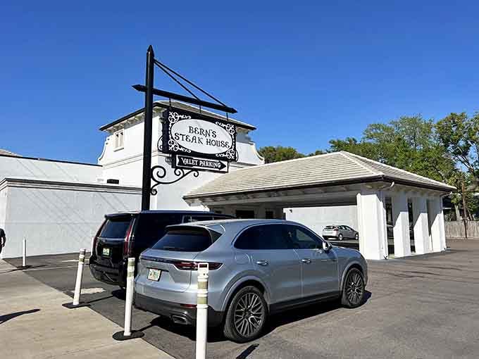 The elegant sign and valet parking hint at something special hiding behind these pristine white walls.