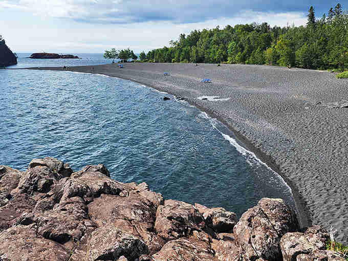 Black sand meets blue water in this unexpected Lake Superior beach that looks like volcanic Hawaii.