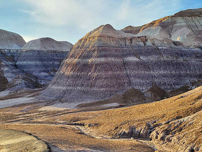 Welcome to Earth's most colorful geology lesson, where purple and blue badlands create an otherworldly masterpiece.