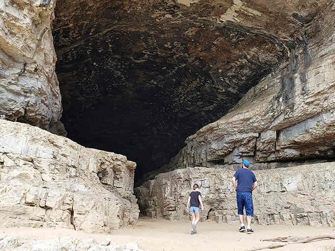 Standing beneath this massive cave opening feels like meeting nature's architecture at its most dramatic and humbling.