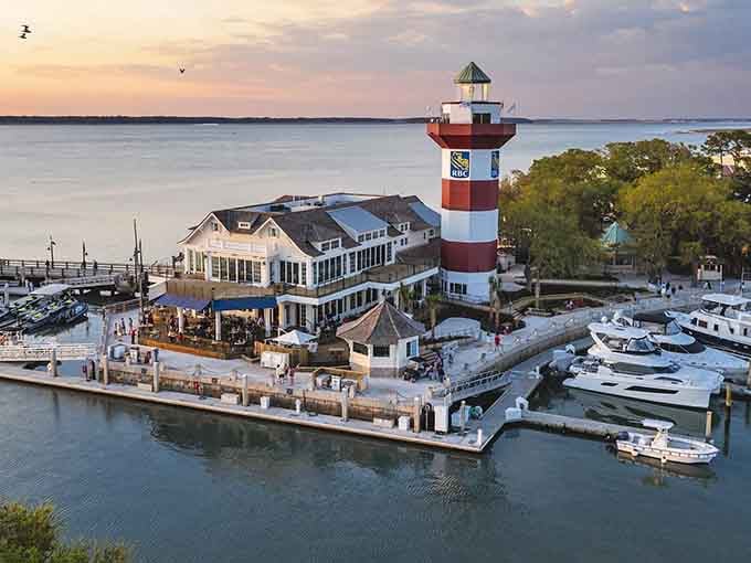 This charming red-and-white striped beauty anchors a bustling marina where Southern hospitality meets nautical elegance perfectly.