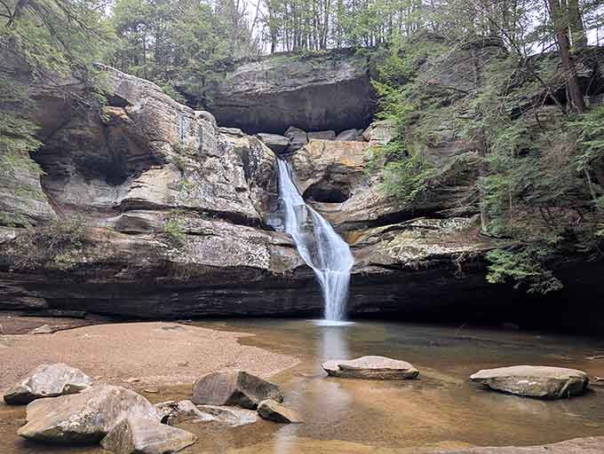 Water cascades over ancient rock layers like nature's own staircase, peaceful and timeless in every season.