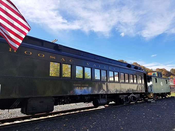 The Hoosac Valley car wears its vintage livery proudly, an American flag waving above like a patriotic exclamation point.