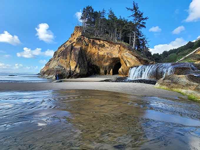 A waterfall meeting the ocean while caves watch from the sidelines&mdash;talk about an overachiever of a beach!
