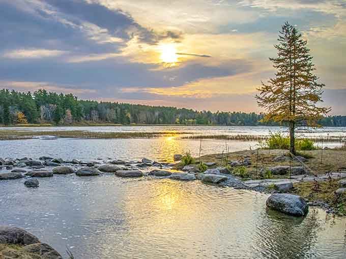 Golden hour at the headwaters paints the sky in watercolor hues, where the mighty Mississippi begins as stones.