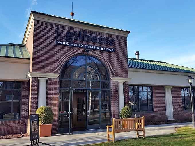 That stunning arched entrance with artistic glass details promises wood-fired magic awaits inside for your taste buds.