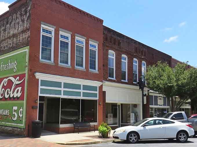 That vintage Coca-Cola sign reminds you when five cents bought happiness and buildings had real character.