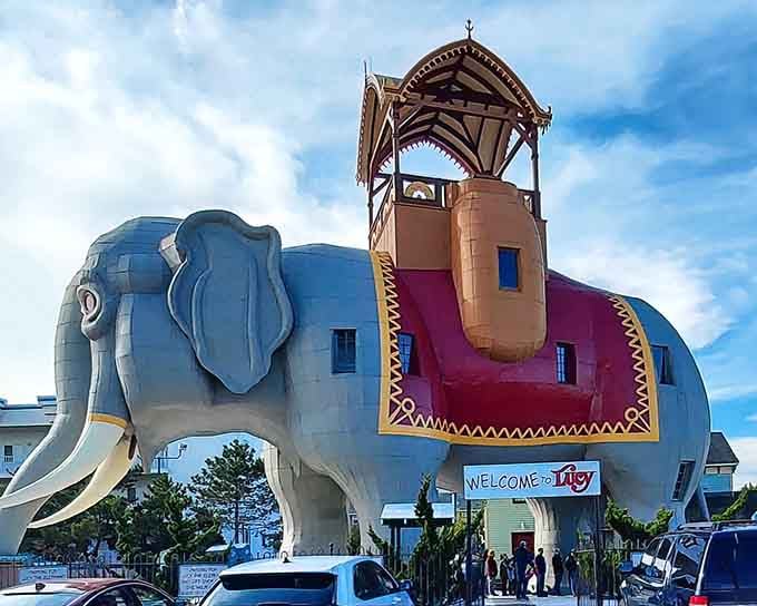 Lucy stands six stories tall in her festive blanket, welcoming visitors like a gentle giant from a Victorian-era fever dream.