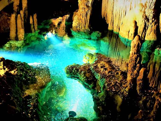 Underground pools glow electric blue and emerald green, creating a scene more fantastical than any movie set.