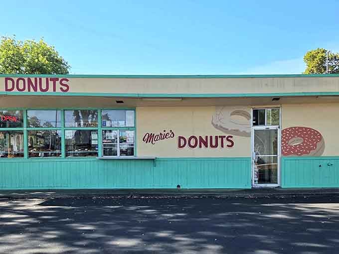 The turquoise and cream exterior whispers of simpler times when donut shops were neighborhood gathering spots, not chains.
