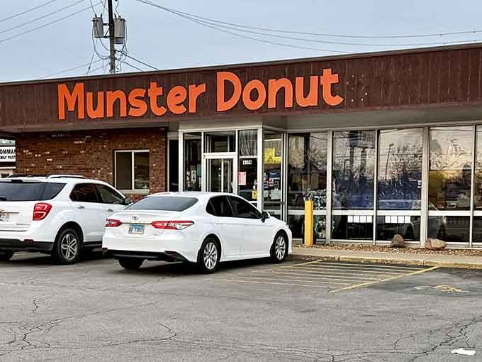Bold orange letters announce your destination for donut bliss, where the parking lot stays busy for all the right reasons.