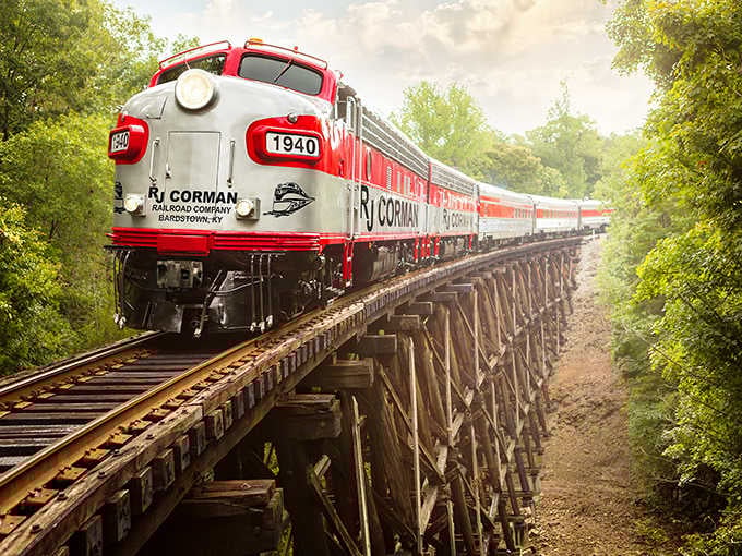 The sleek red-and-white dinner train crossing this wooden trestle combines engineering marvel with pure dining elegance beautifully.