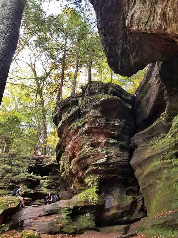 Walking beneath this stone overhang feels like stepping into nature's own cathedral, complete with dramatic arches.