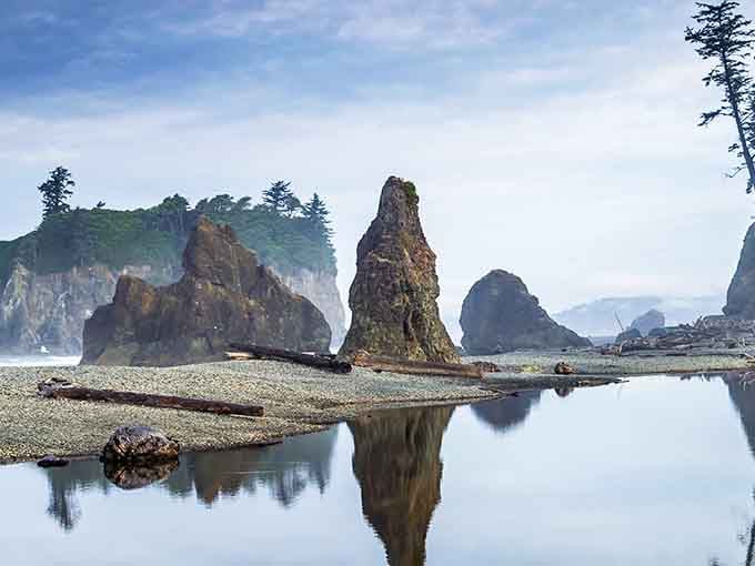 When tide pools become mirrors, reflecting sea stacks like a natural kaleidoscope that would make Ansel Adams weep.