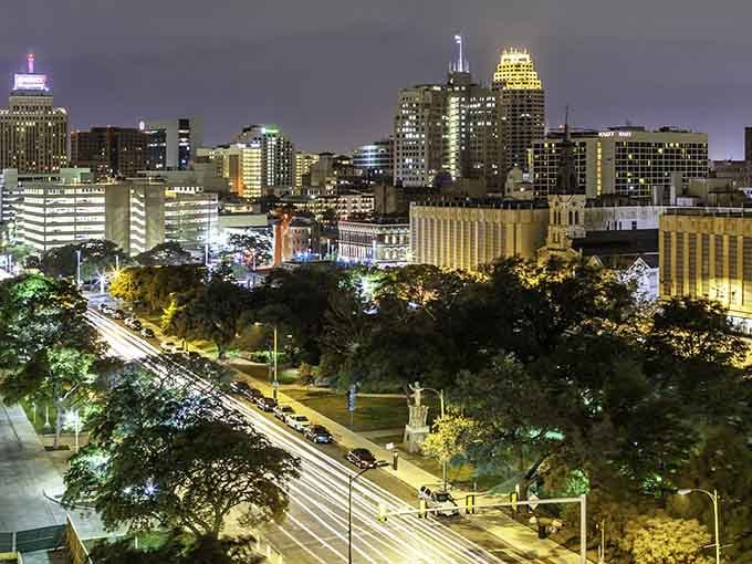 When the sun sets, San Antonio's skyline glows like a jewel box, with historic buildings bathed in golden light beneath purple clouds.
