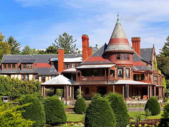 This Victorian mansion rises like a wedding cake of turrets and chimneys, surrounded by perfectly manicured emerald lawns.