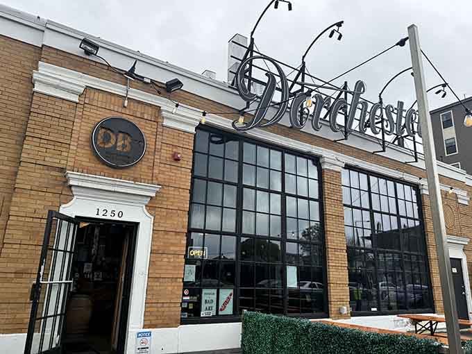That industrial-chic brewery entrance promises craft beer inside, but the real draw is the wonderfully terrible art upstairs.
