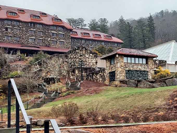 Those massive stone walls rising from the misty mountains give off serious Overlook Hotel vibes, minus Jack Nicholson.