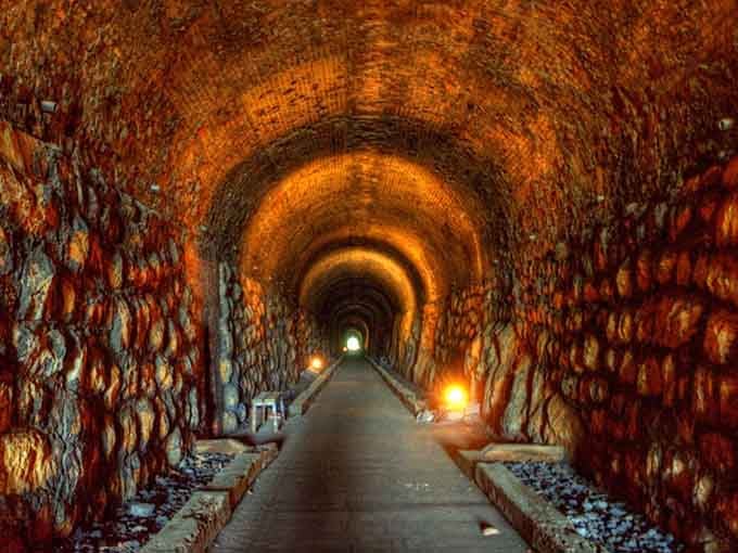 Step into this glowing brick tunnel where every footstep echoes like whispers from another century calling you forward.