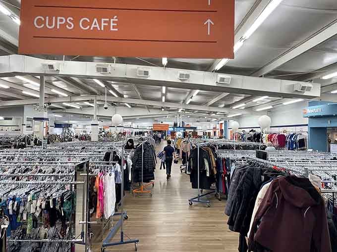 Endless racks stretch like a clothing lover's dream, organized and bright as a department store minus the guilt.