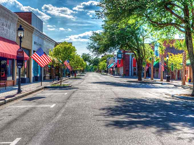 American flags line Walterboro's main street like patriotic sentries guarding small-town charm and century-old storefronts below.
