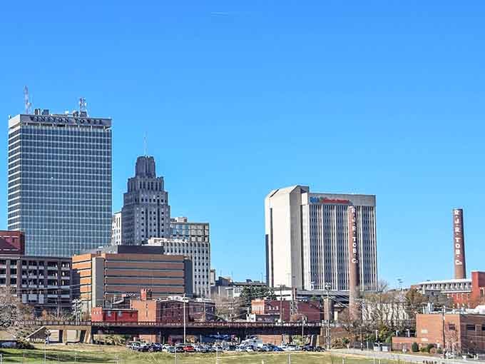 The skyline rises with confident grace, mixing architectural styles like a well-composed symphony against Carolina blue skies.