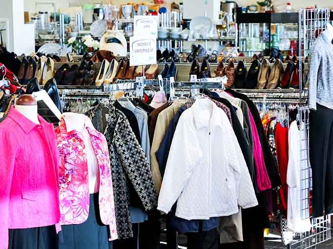 A vibrant pink blouse catches the eye among racks bursting with colorful possibilities and hidden designer gems.