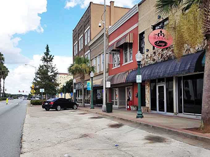 Local storefronts stand proud along this quiet boulevard, where parking spots outnumber the stress you left behind.