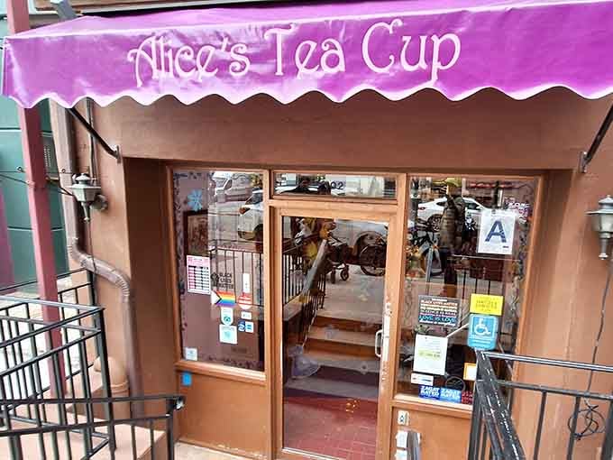 The open door reveals a cozy interior where every teacup tells a story and every scone deserves its own spotlight.