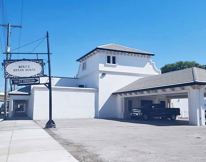 This crisp white building looks like a Mediterranean villa where serious steak lovers gather for unforgettable meals.