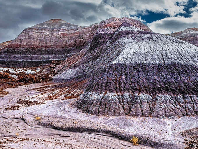 These striped hills look like someone mixed a sunset with clay, creating nature's most beautiful marble cake.