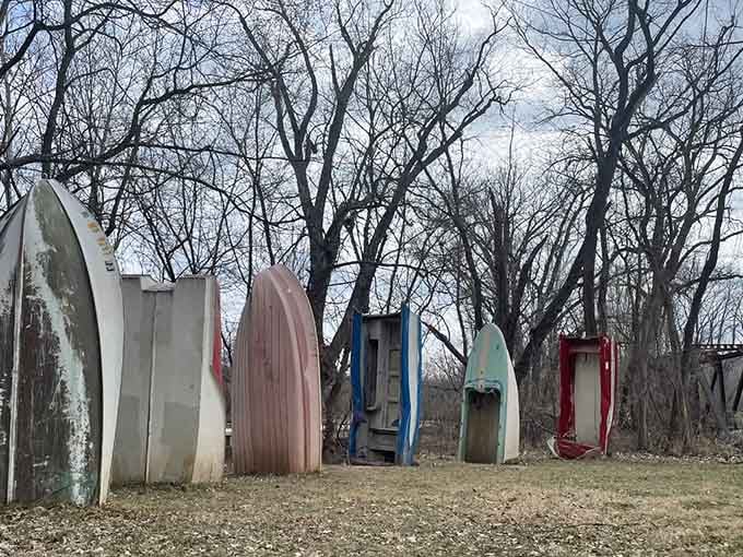 Winter's bare trees frame these weathered vessels standing sentinel like ancient monoliths, creating an unexpectedly haunting art installation.