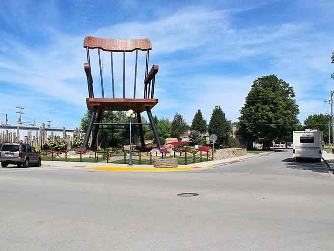 That giant rocking chair towers over the street like something from a fairy tale where everything grew three sizes overnight.