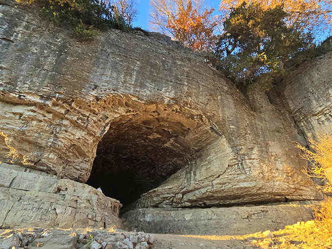 The golden autumn light transforms this river cave into something straight from an Indiana Jones adventure scene.