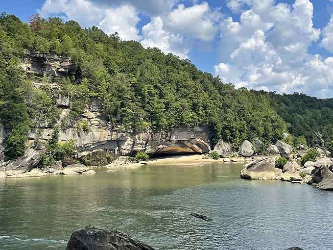 Calm waters mirror the towering cliffs above, creating a scene so peaceful you'll forget your phone exists.