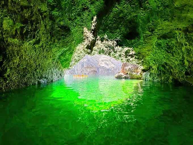 The green water and moss-draped walls create a scene straight out of an adventure novel.