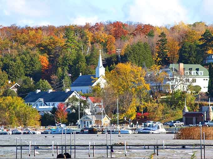 Autumn transforms this lakeside village into a painter's palette of orange, red, and gold against brilliant blue water.