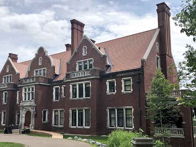 The darker brick facade and towering chimneys give this estate a stately presence that commands respect and admiration.