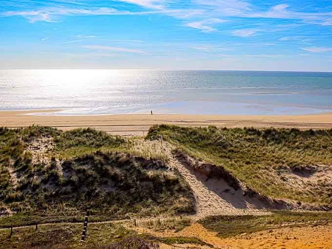 That endless stretch of sand meets sparkling water in a view that makes crowded beaches feel like a distant memory.
