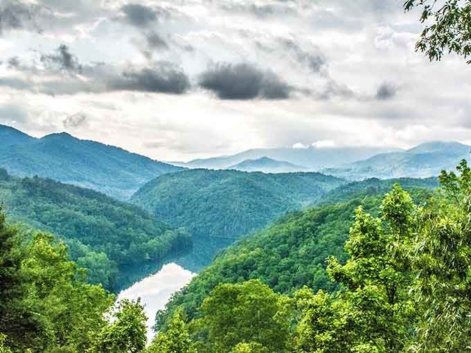Morning mist clings to these ancient peaks like nature's own special effects department working overtime for your visit.