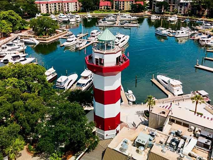 Nestled among gleaming yachts and emerald waters, this candy-striped landmark proves lighthouses can have excellent neighbors.