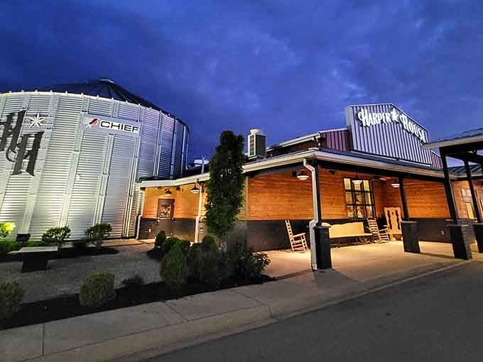 Evening lights illuminate this creative steakhouse design, blending industrial charm with warm wooden accents perfectly.