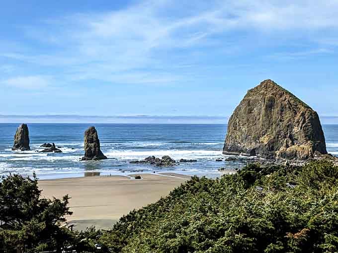 Standing sentinel where ocean meets shore, this massive rock has witnessed more sunrises than we can count.