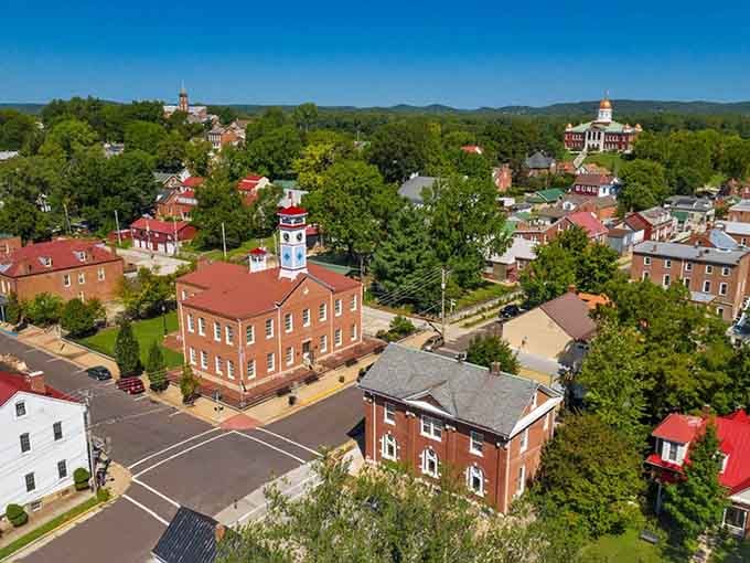 From above, the red rooftops create a patchwork quilt that stretches toward distant hills and endless blue skies.